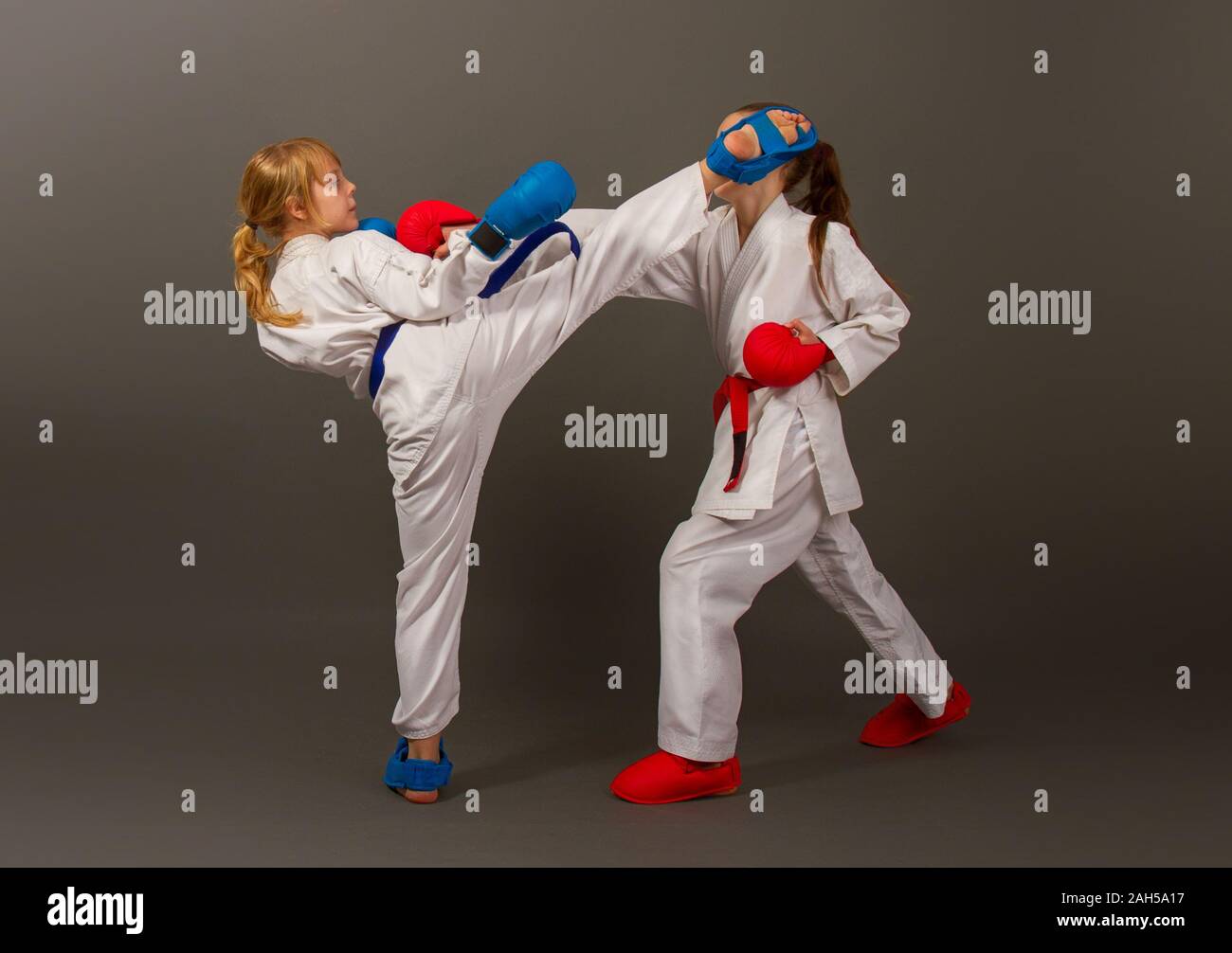 Sport Karate fight two little girls in white kimono in red one second ...