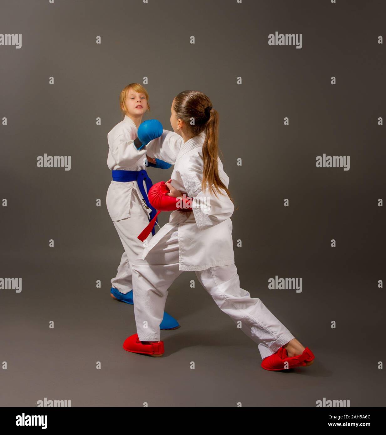 Sport Karate fight two little girls in white kimono in red one second ...