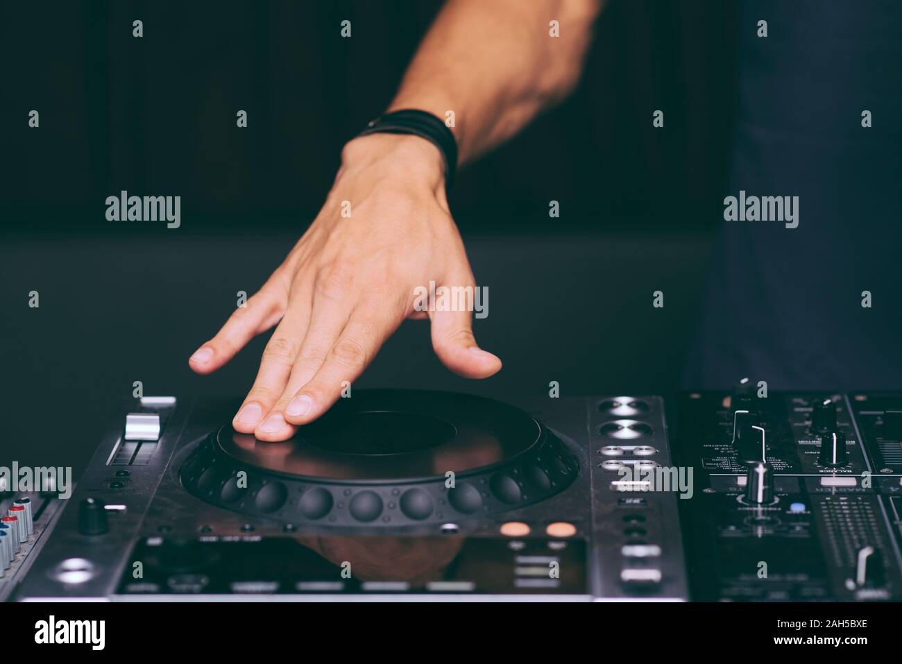 DJ controls a remote at a club party Stock Photo - Alamy