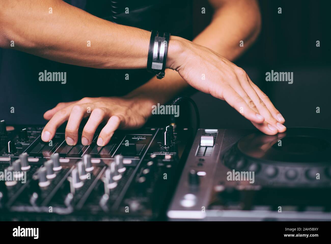 DJ controls a remote at a club party Stock Photo - Alamy