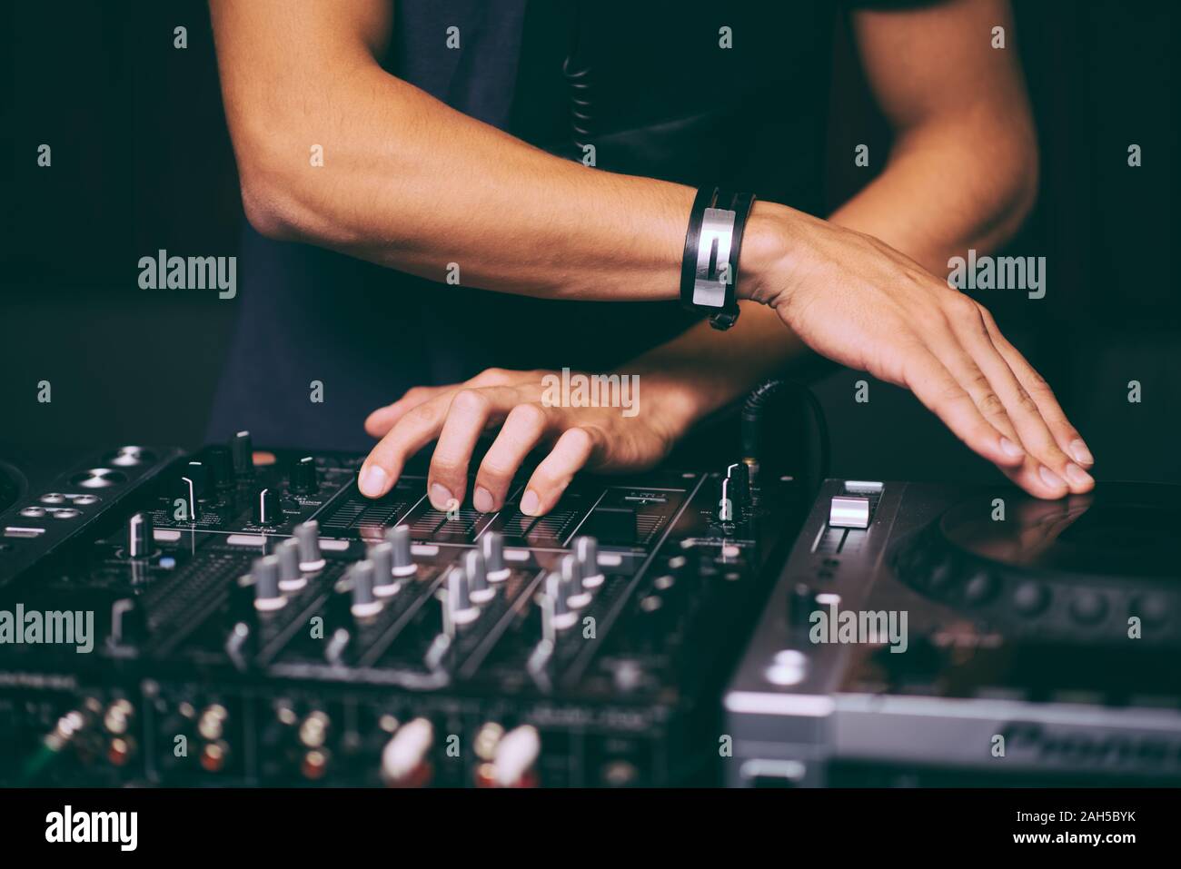 DJ controls a remote at a club party Stock Photo - Alamy