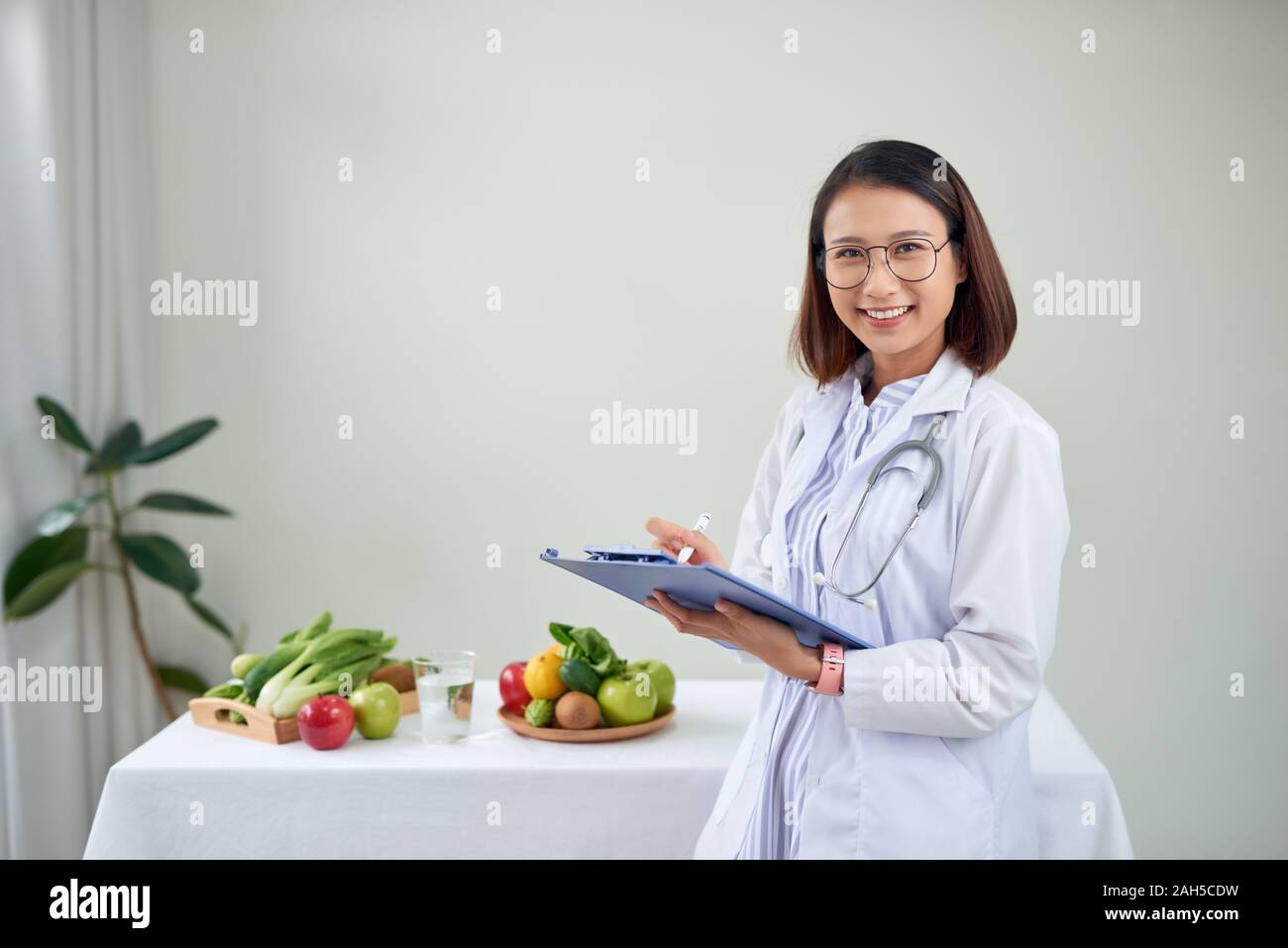 Nutritionist desk with healthy fruits, juice and measuring tape ...