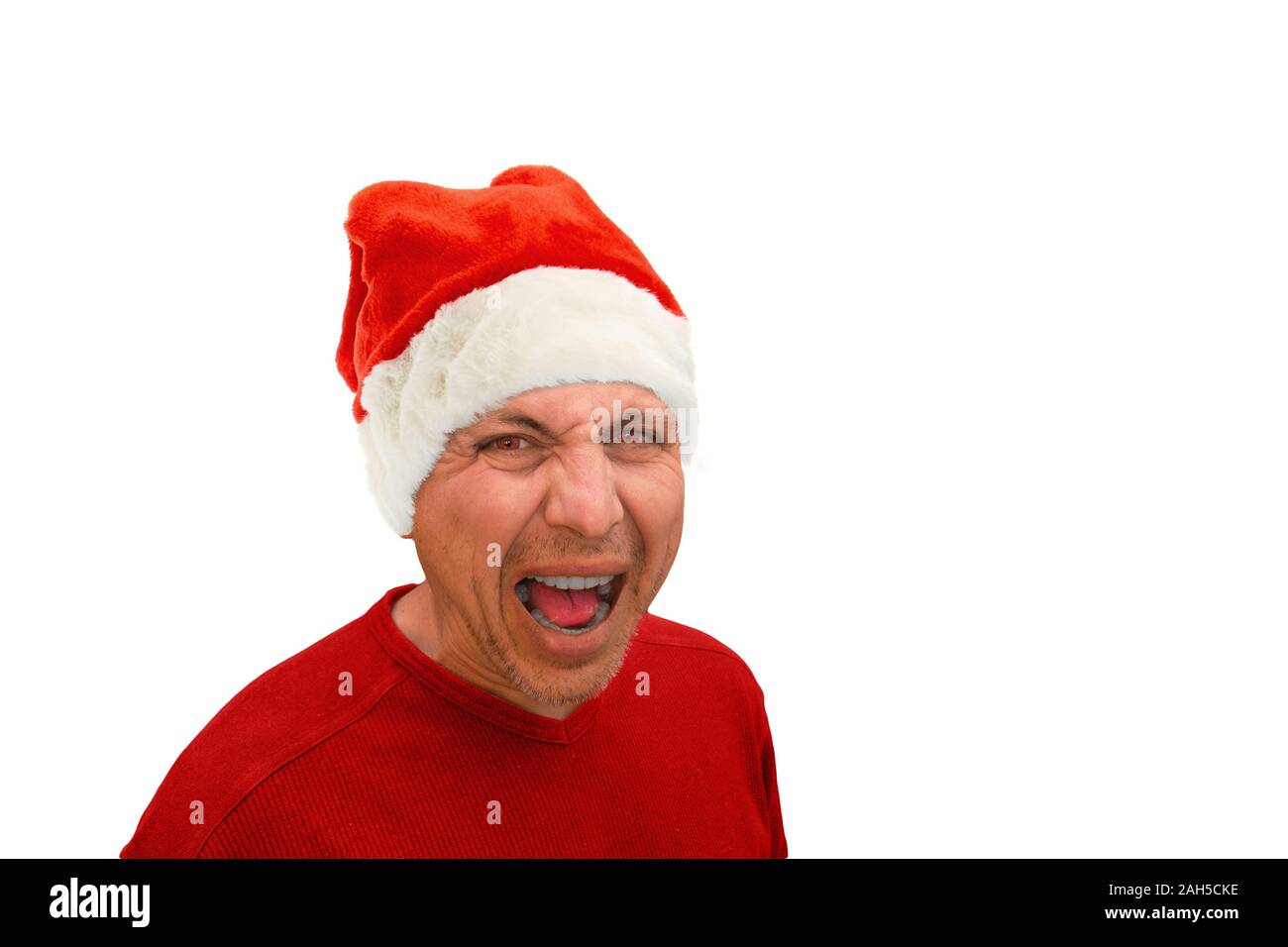 Furious Santa. Man with angry face in Santa Claus hat looks into camera ...