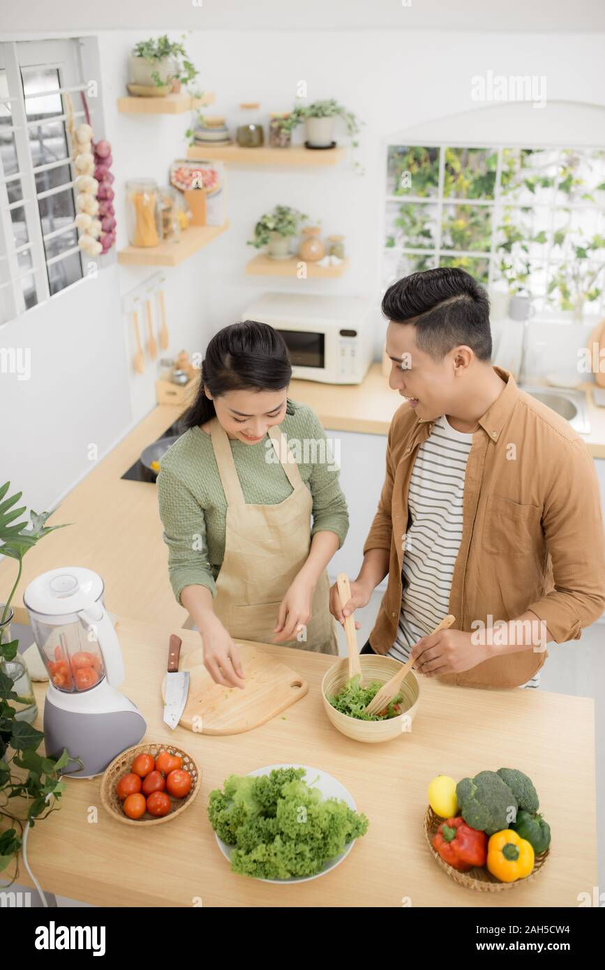 Happy young couple cooking in the kitchen. Top view Stock Photo - Alamy