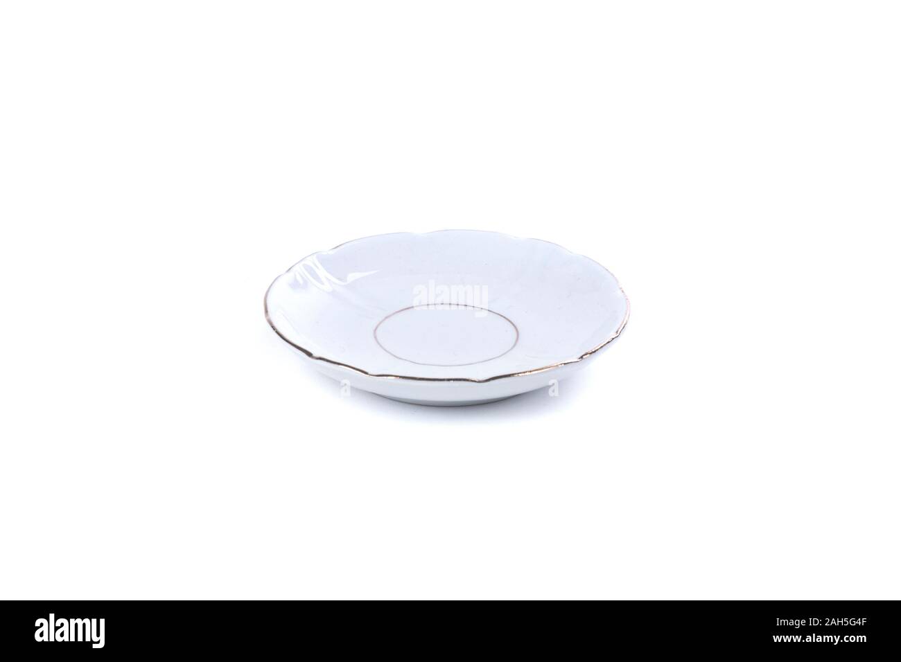 Tiny white tea plate saucer with gold edging Stock Photo - Alamy