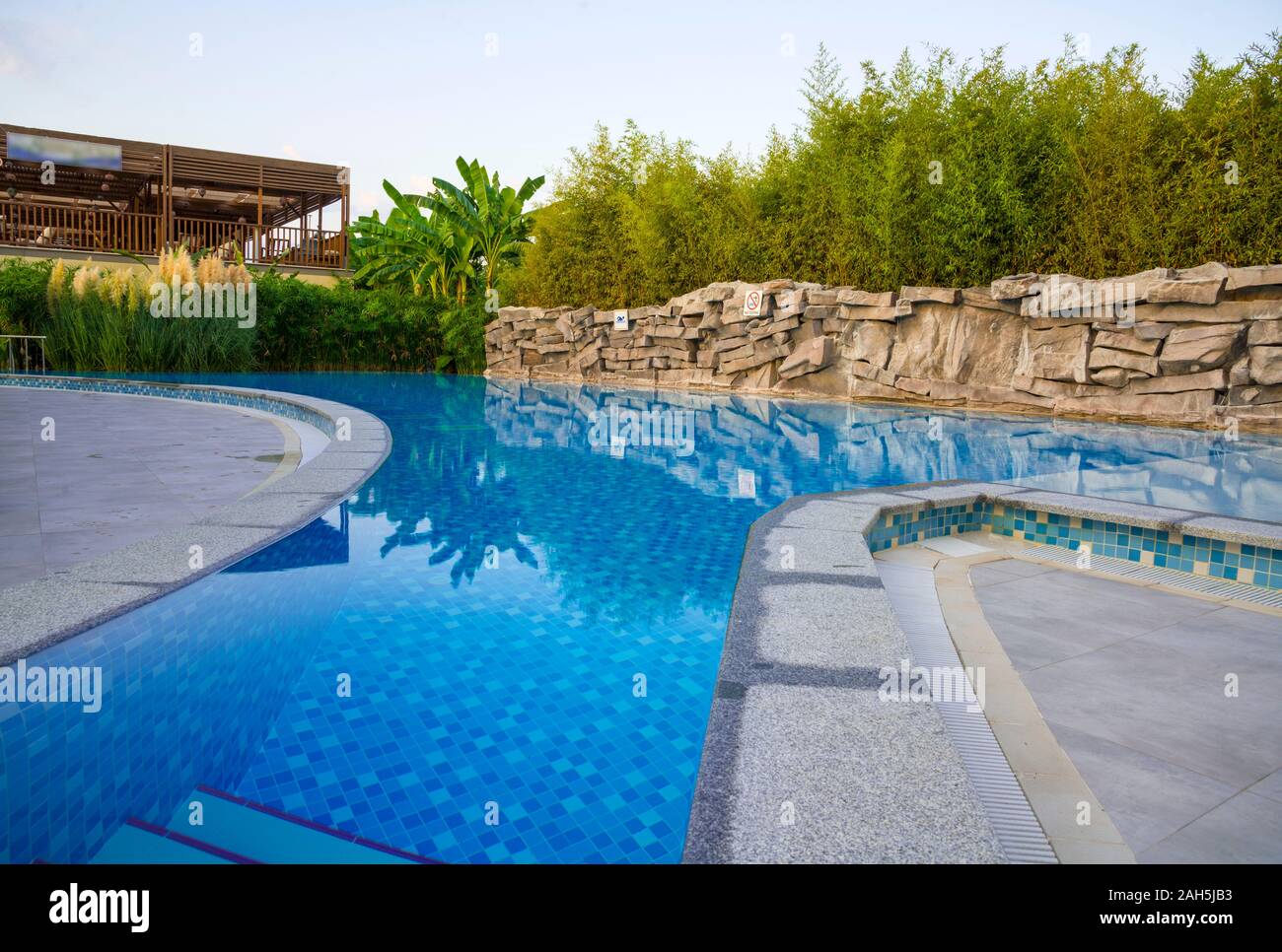 Swimming pool in the summer resort. Blue water Stock Photo - Alamy
