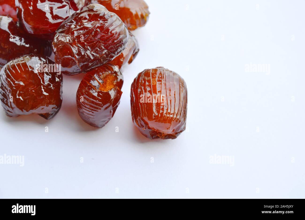Chinese jujube candy coating syrup on white background Stock Photo - Alamy