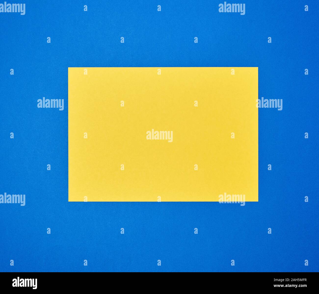 blank yellow sheet of A4 paper on a blue background. Business template ...