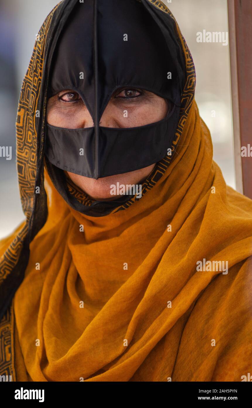 An Omani Bedouin woman wearing a traditional Batoola face covering ...