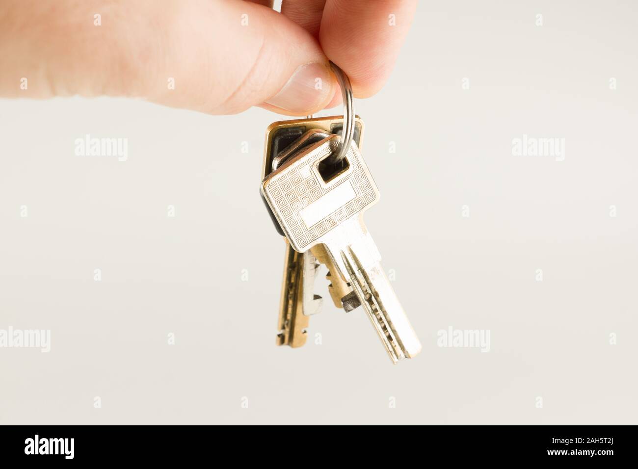 big bunch of different keys in hand isolated on a white background ...