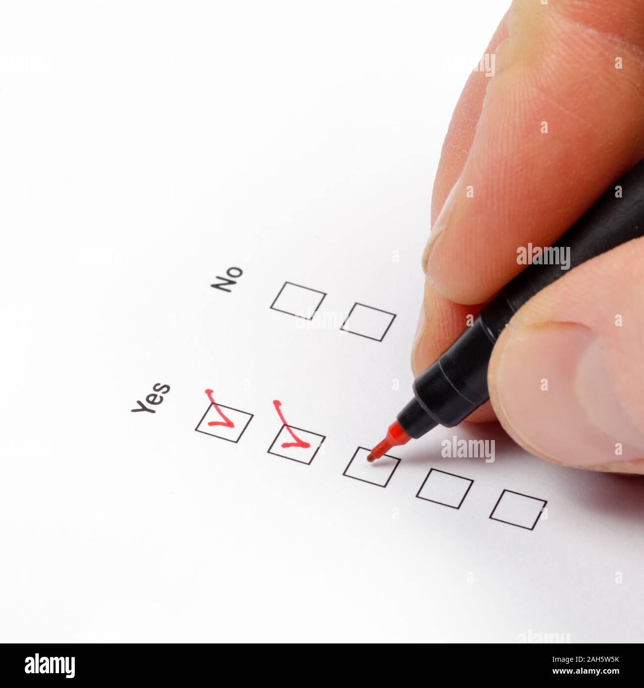 Hand with pen over blank check box Yes in application form Stock Photo ...