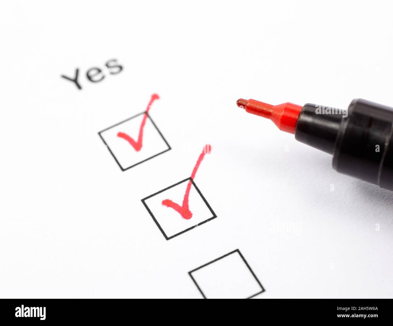 Close up shot of filled check boxes Yes with red pen Stock Photo - Alamy