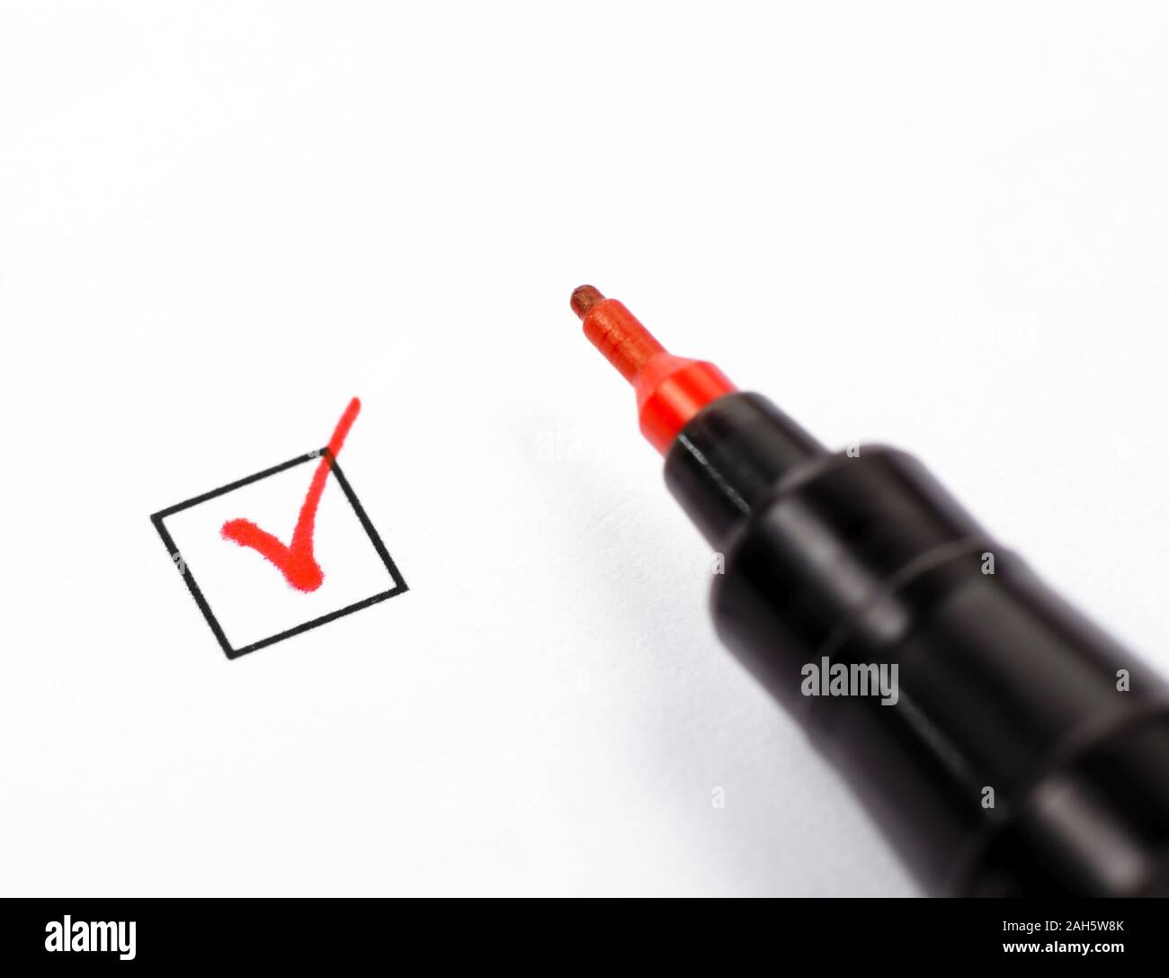 Close-up shot of filled check box and red marker Stock Photo - Alamy