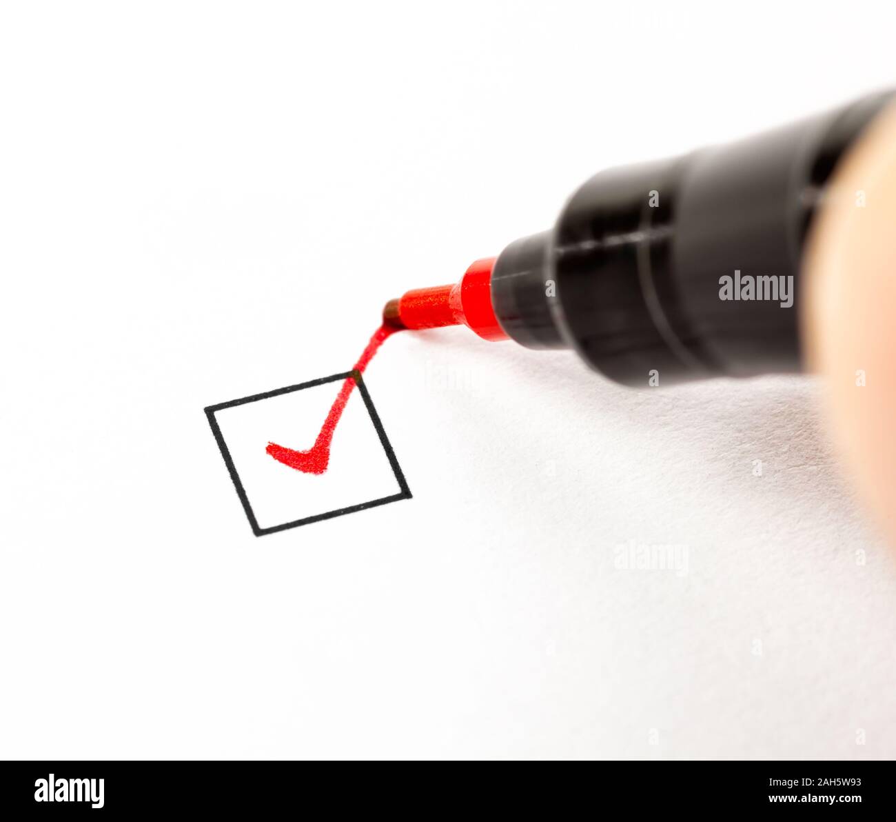 Person putting a mark in a check box with red marker Stock Photo - Alamy