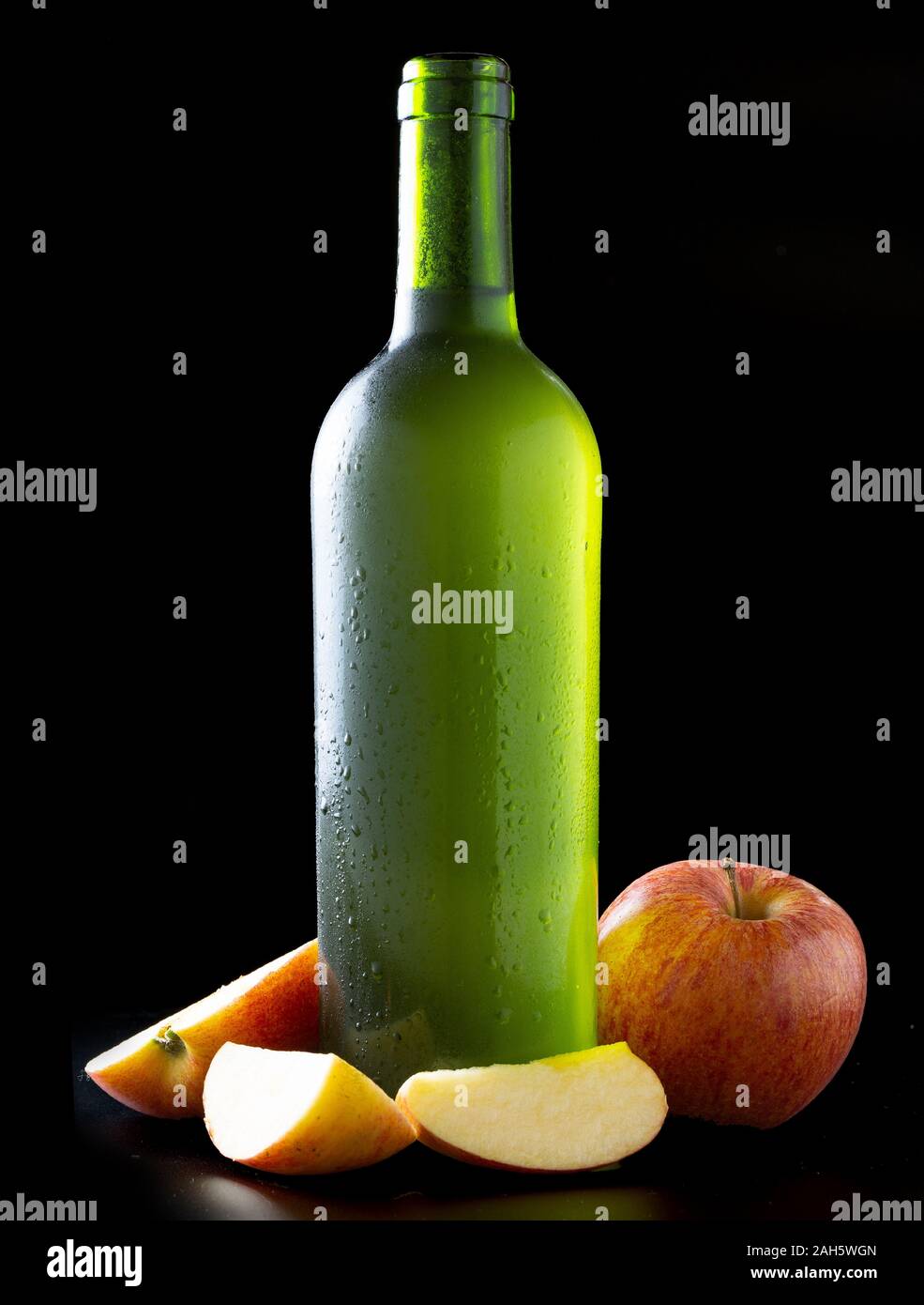Bottle of very cold cider with apples with black background Stock Photo ...