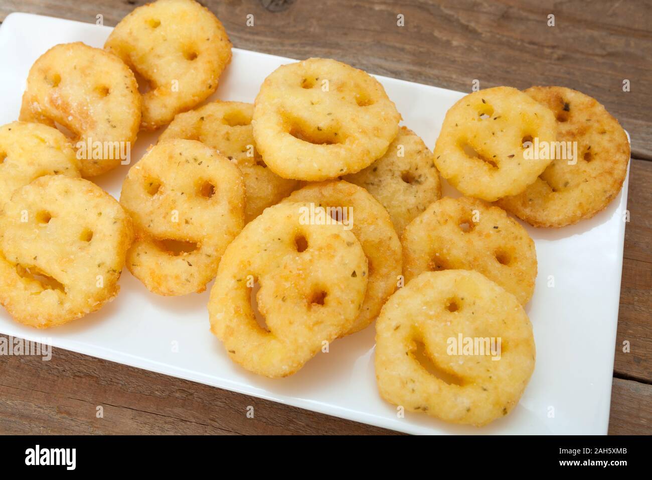 Potato fried smileys chips Stock Photo - Alamy