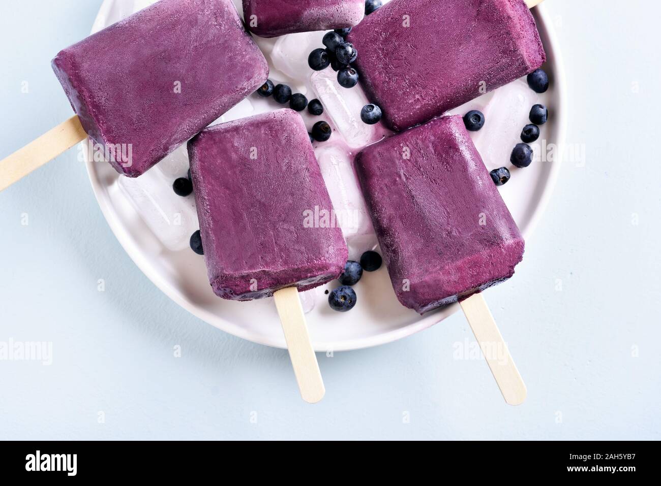 Blueberry popsicles on blue stone background. Cold summer dessert. Top ...