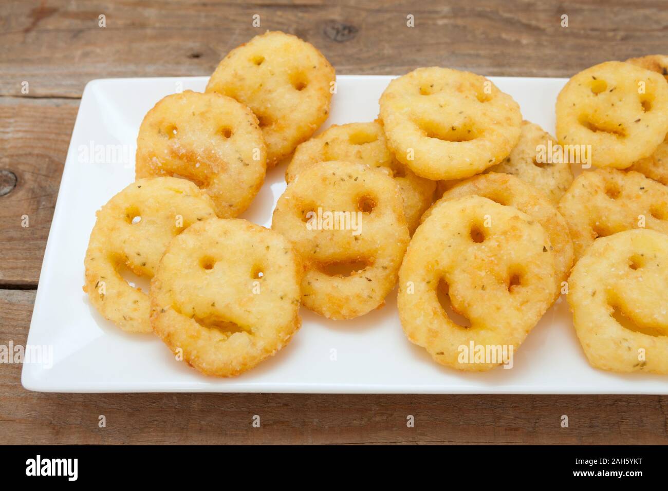 Potato fried smileys chips Stock Photo - Alamy