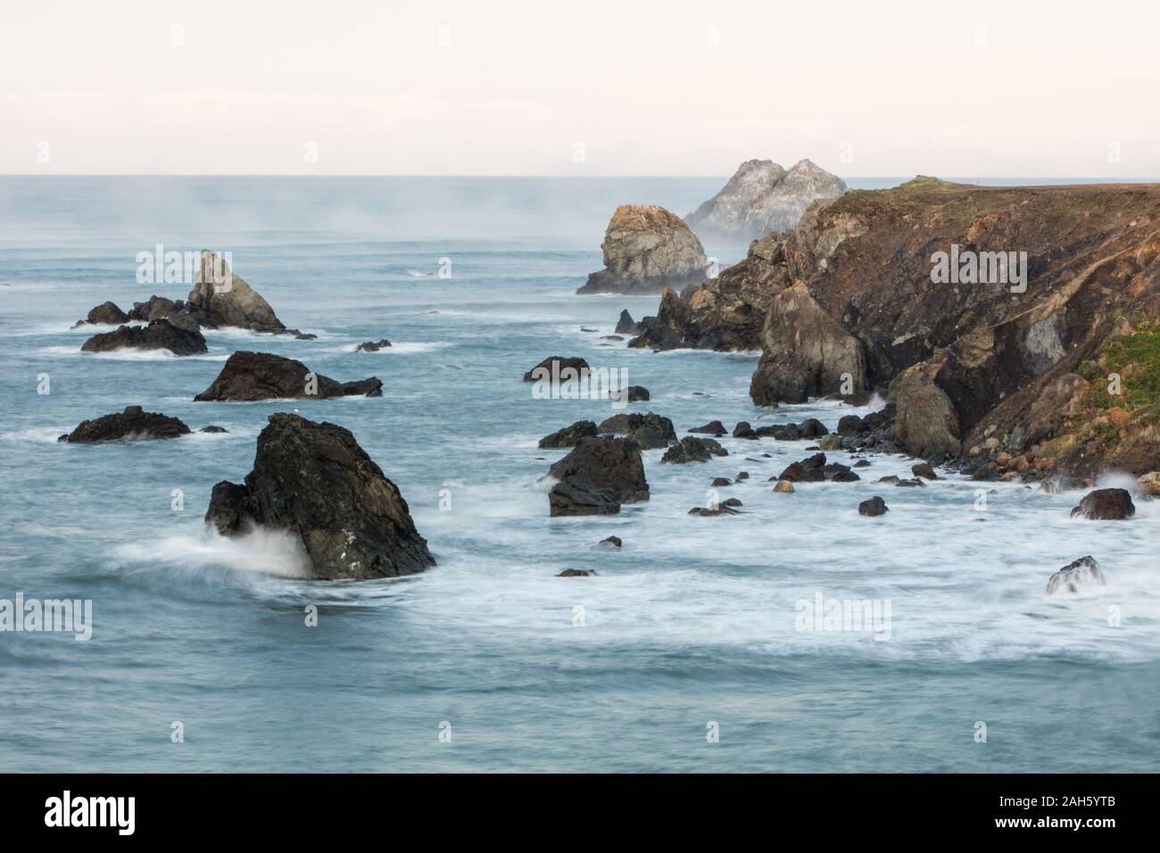 The Pacific Ocean washes against the rugged coastline of northern ...