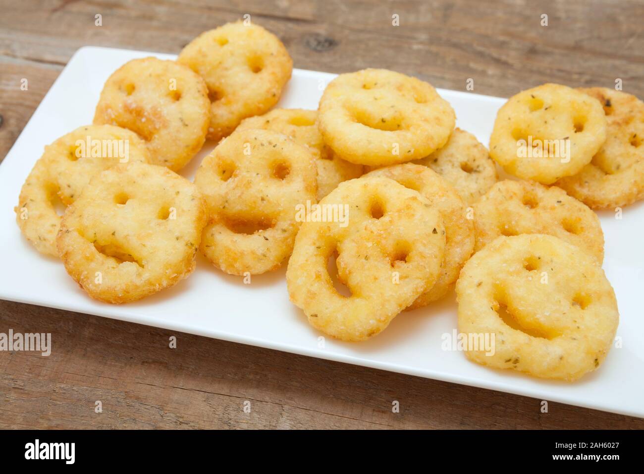 Potato fried smileys chips Stock Photo - Alamy