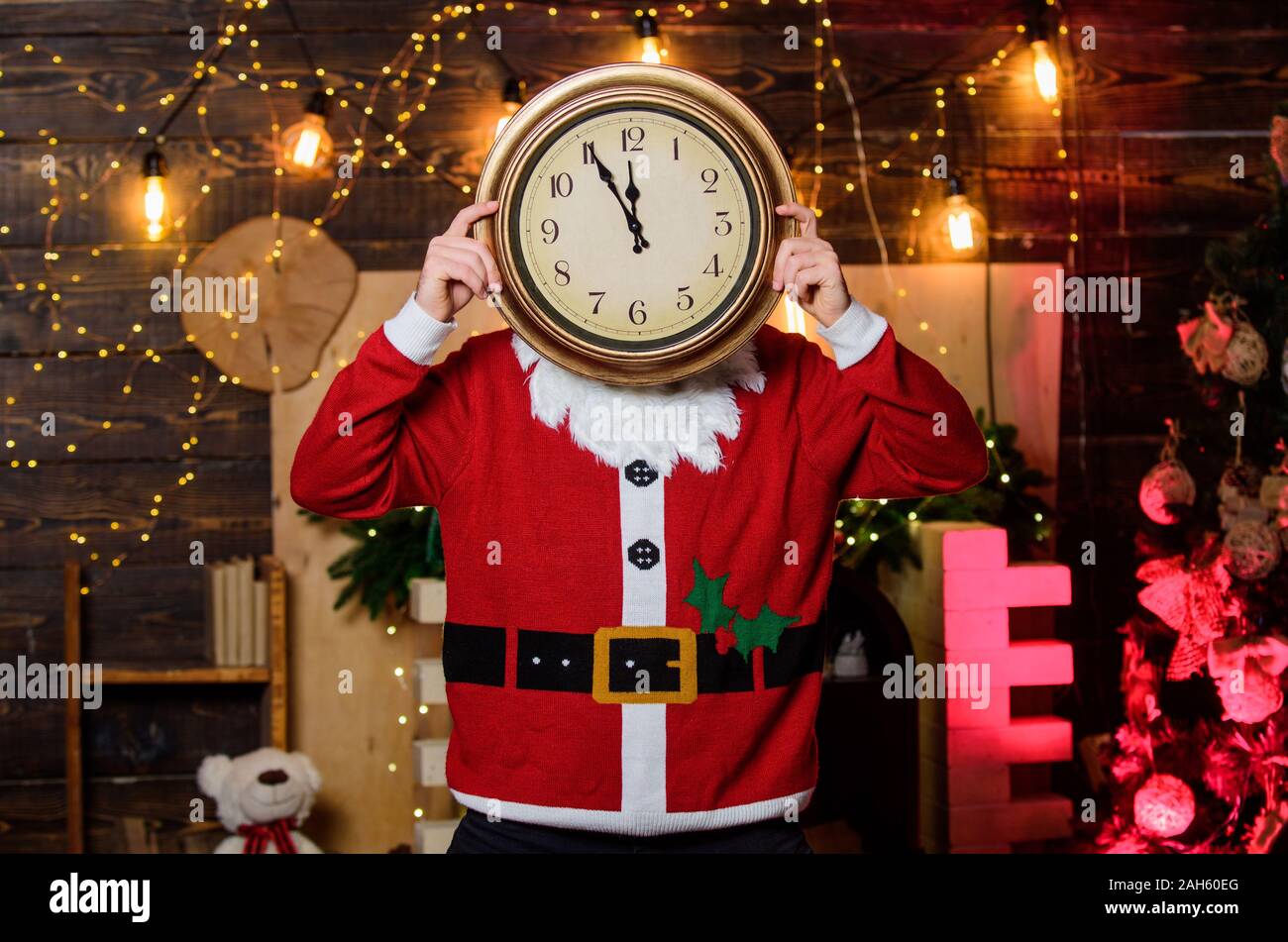 Almost midnight. Make wish. Santa claus hold vintage clock. Time to ...