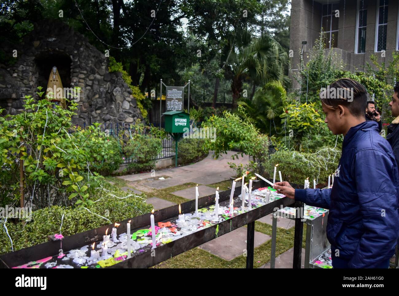 A Christian devotee lights a candle during the celebration at Christ ...