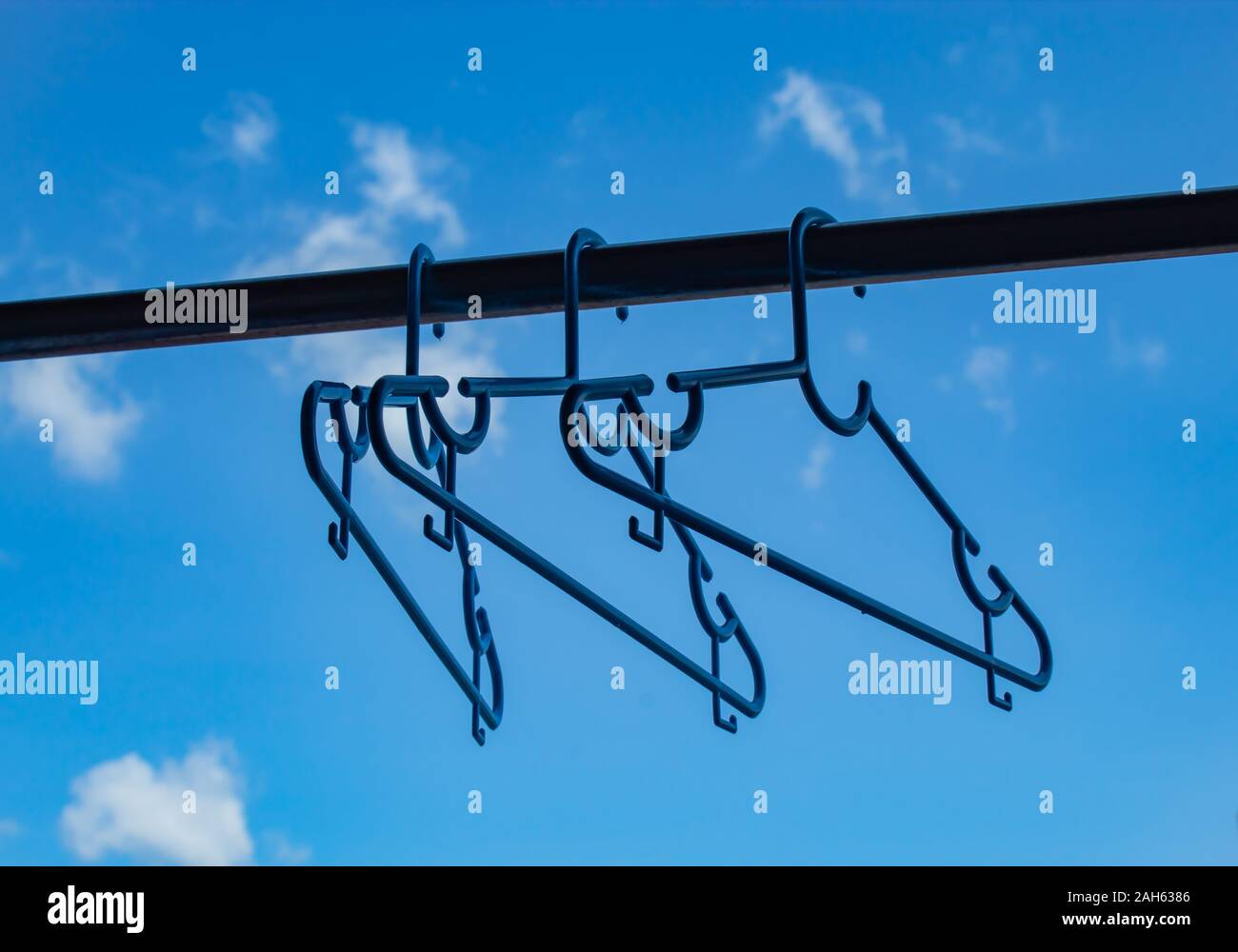 The hanger blue on the rails, stainless steel Stock Photo - Alamy