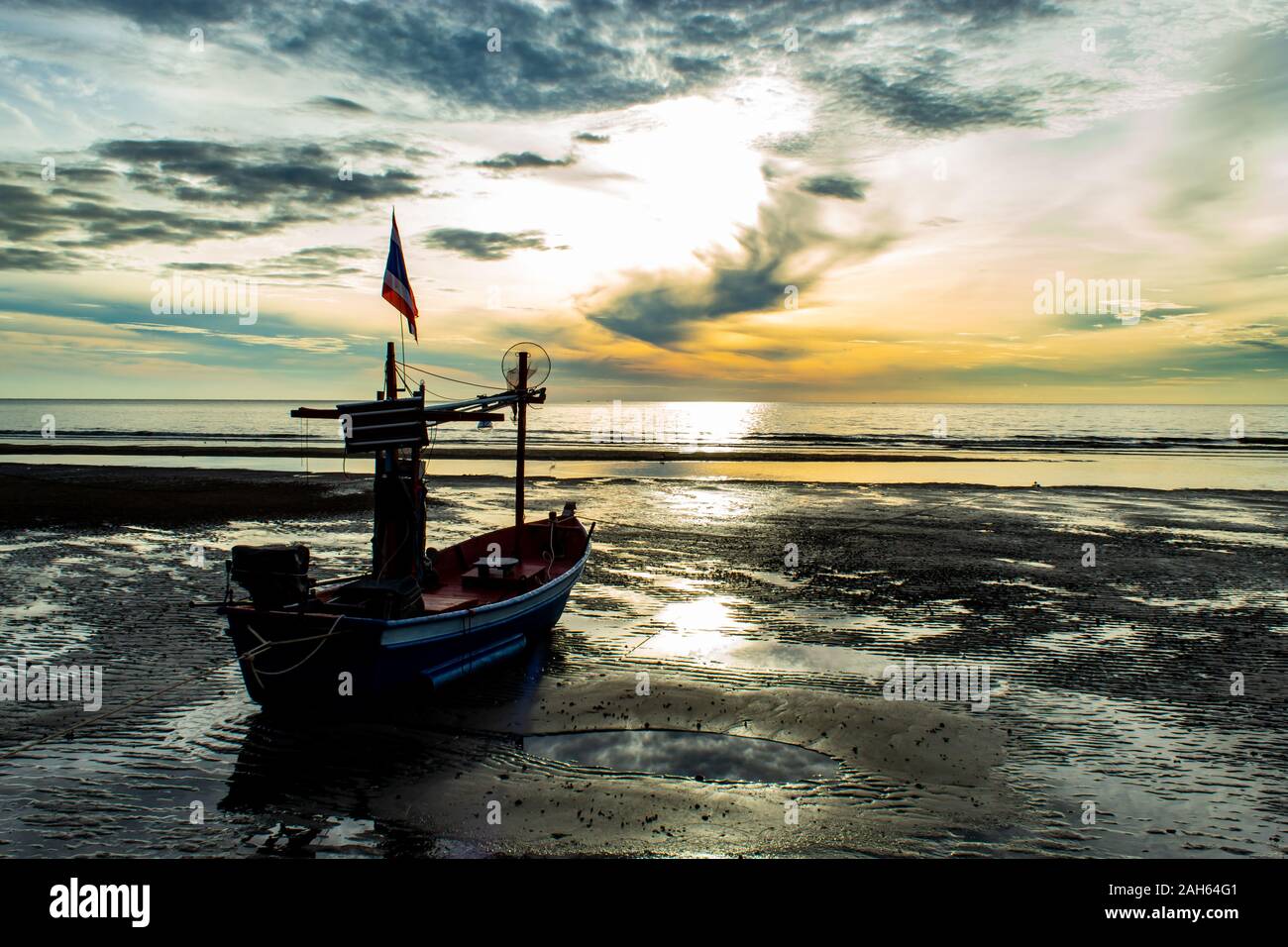 The morning sun light in the sea, and the boat on the beach Stock Photo ...
