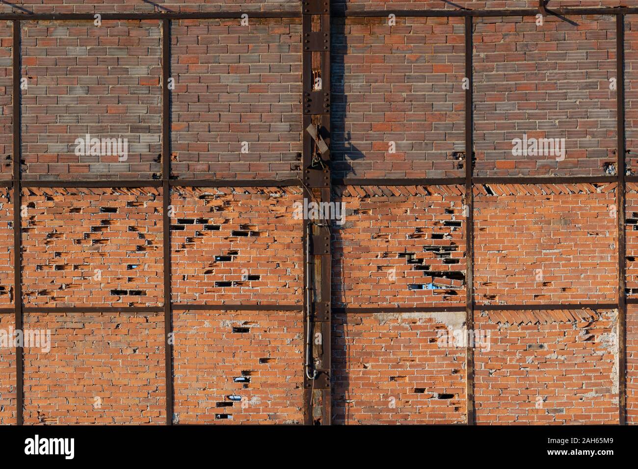 Old brick wall with holes and rusted metal beams Stock Photo - Alamy