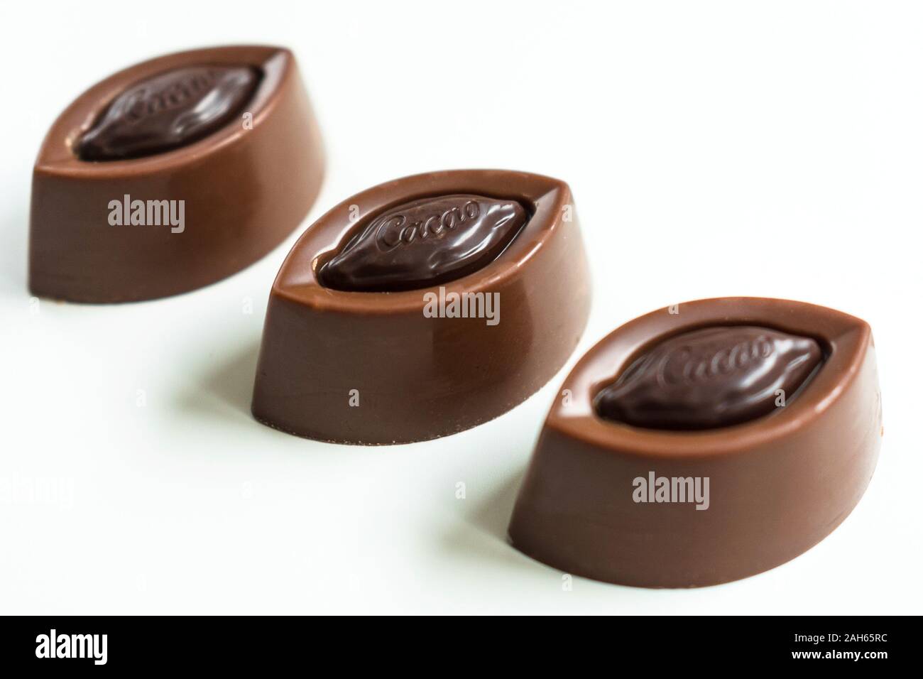 Three chocolates isolated on a white background. Close-up Stock Photo ...