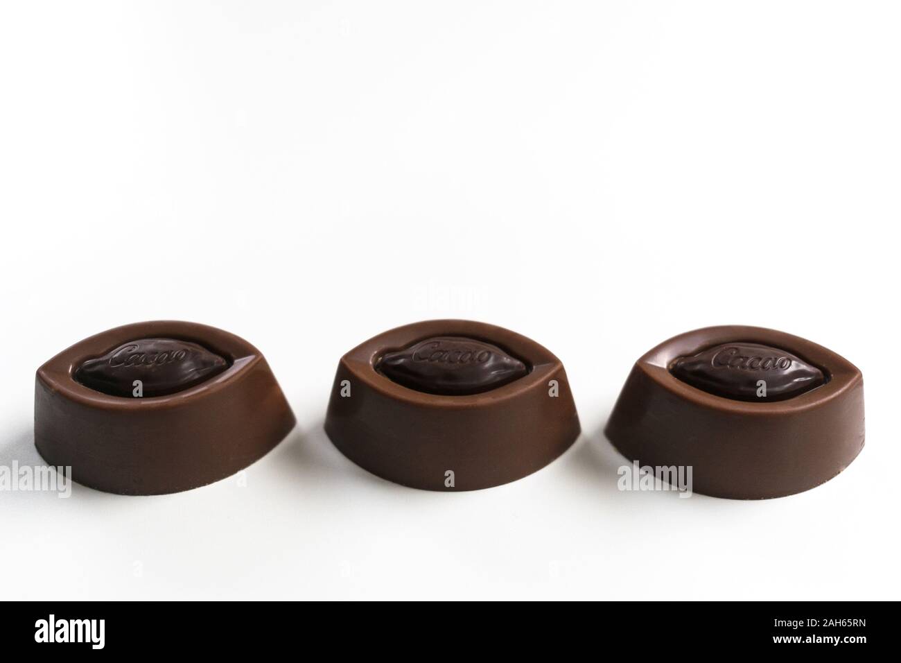 Three chocolates isolated on a white background. Close-up Stock Photo ...