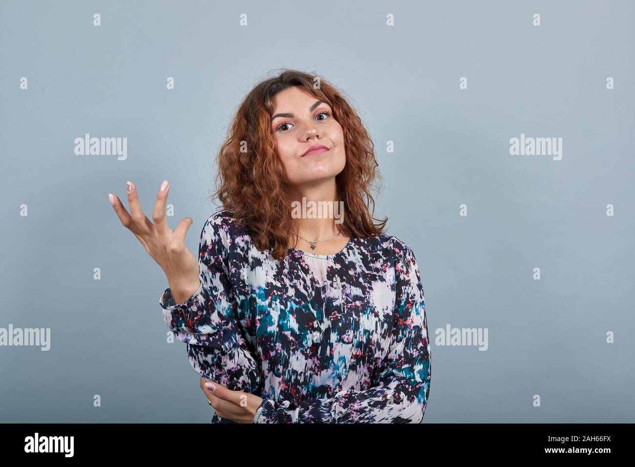 Disappointed charming young lady spreads hand, looking unhappy Stock ...