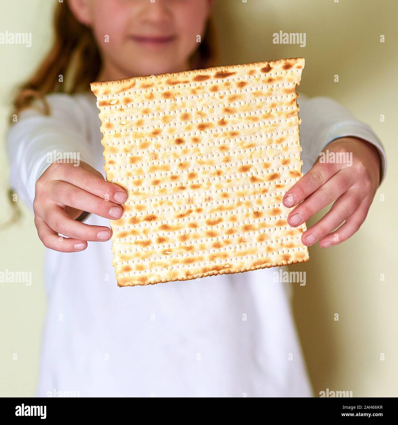Young Jewish girl holding matzah for Passover Stock Photo - Alamy