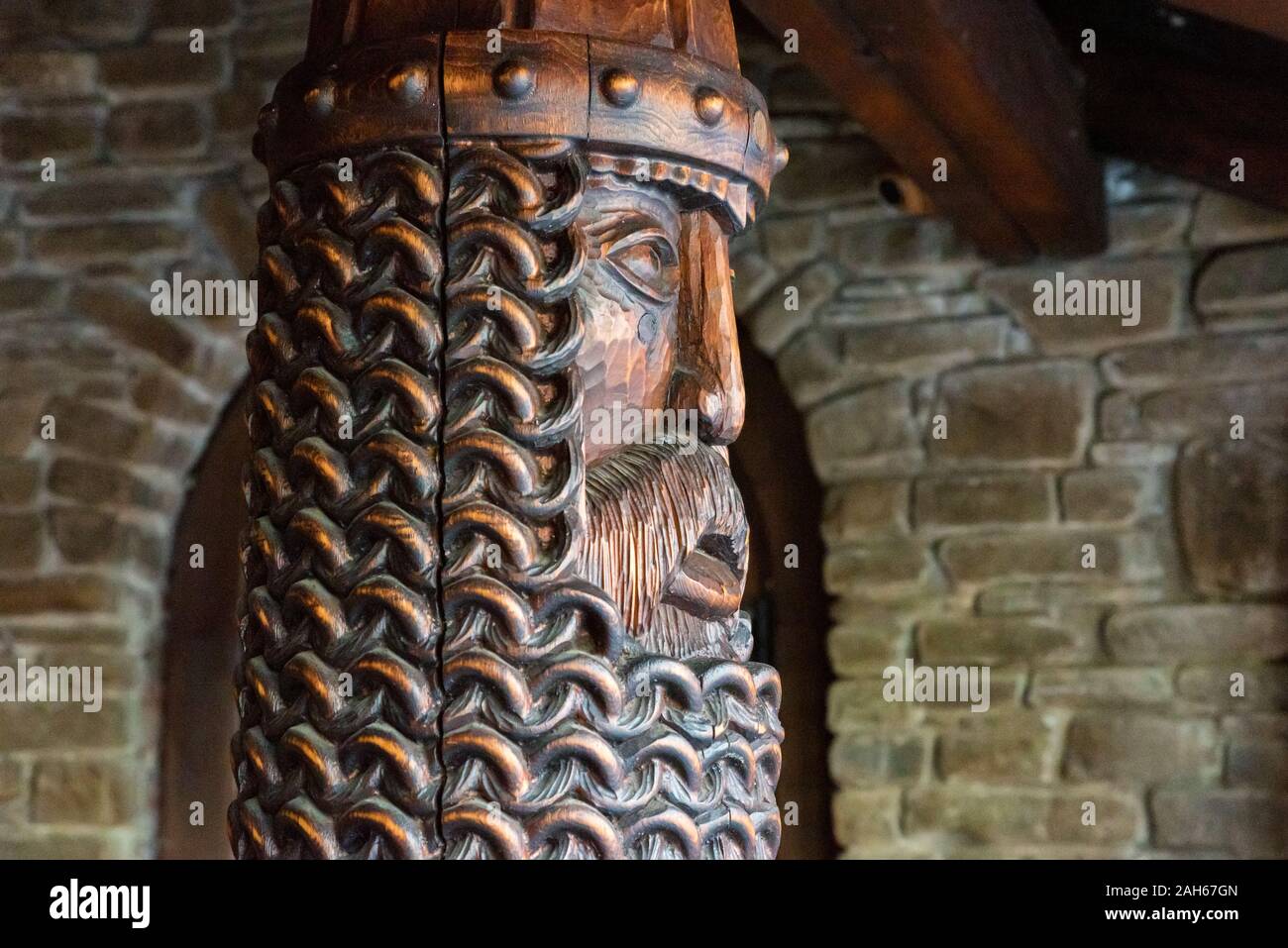 Close up wooden pole with carved face of traditional Russian epic ...