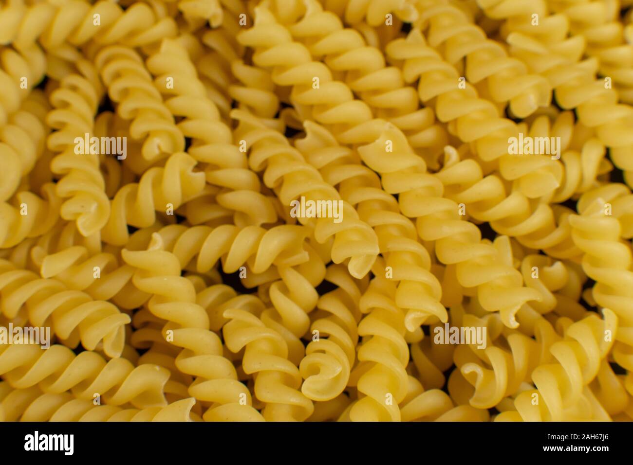 background formed by spiral shaped pasta Stock Photo - Alamy