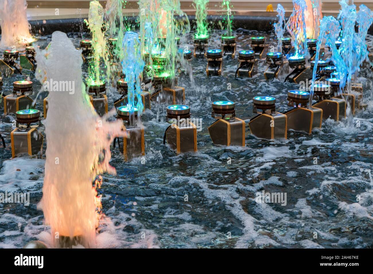 Close view of water and colorful lamps in fountain in modern urban ...