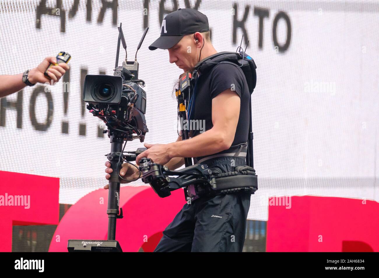 Steadicam camera man online broadcasting from stage Stock Photo - Alamy