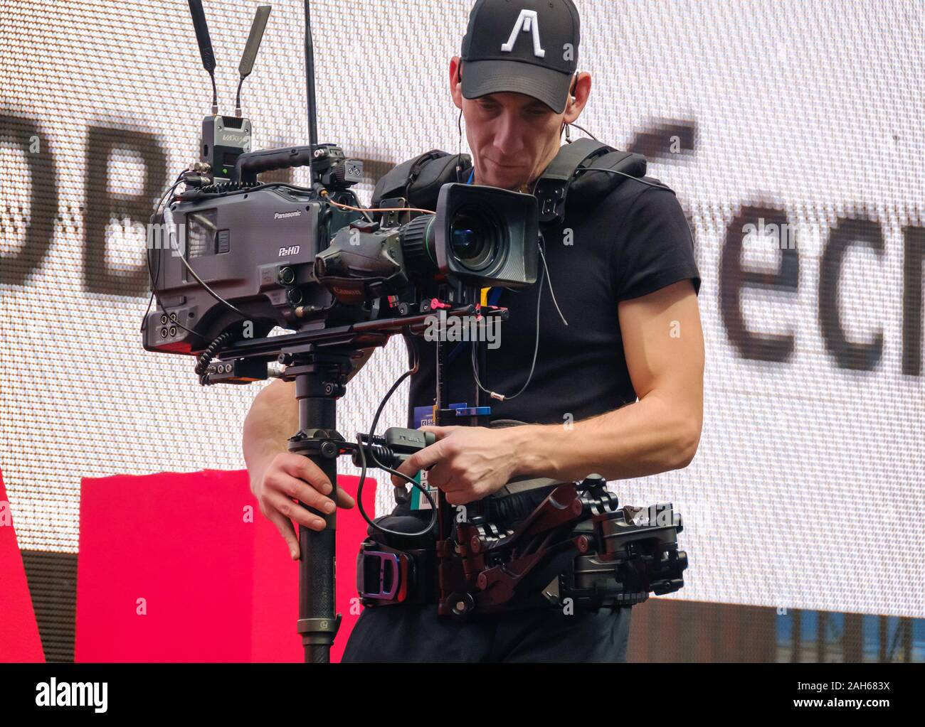 Steadicam camera man online broadcasting from stage Stock Photo - Alamy