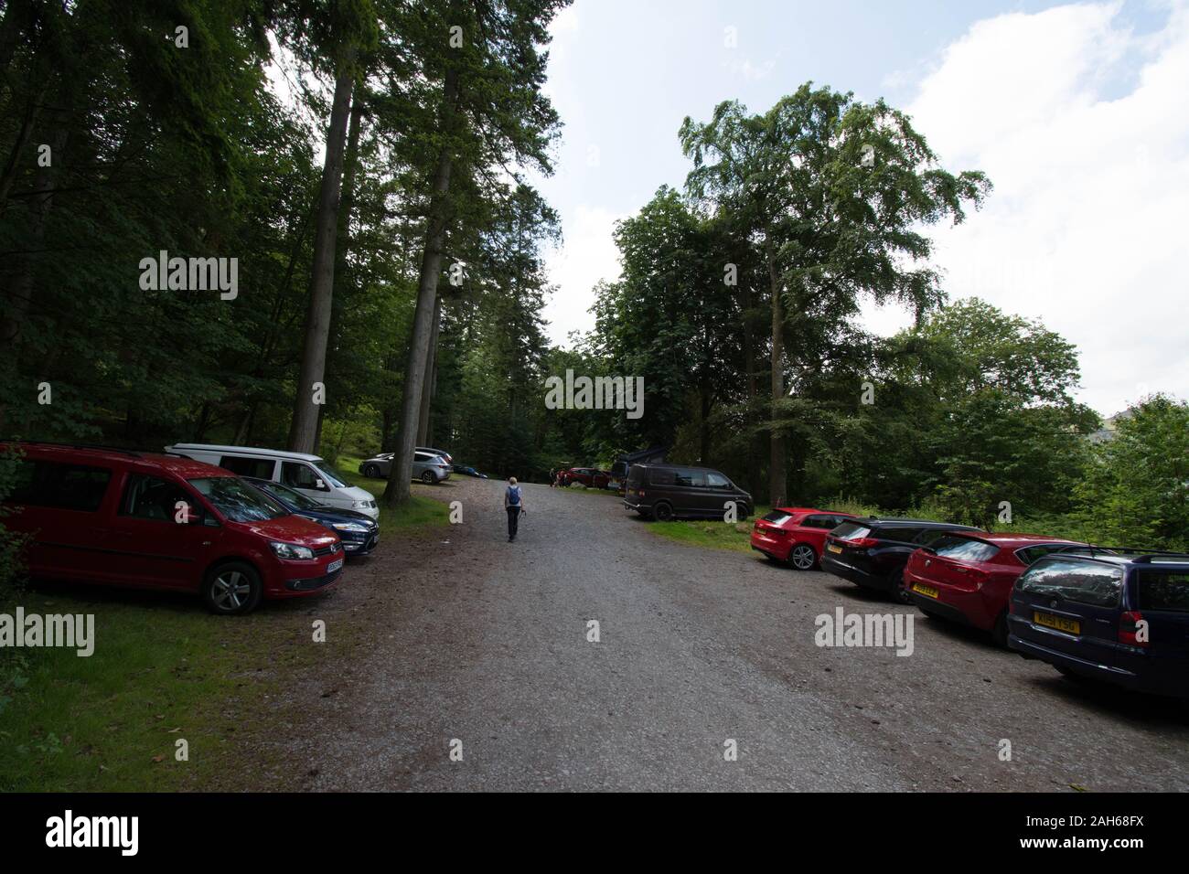 Lake District in Keswick with walker in the distance and lots of cars ...