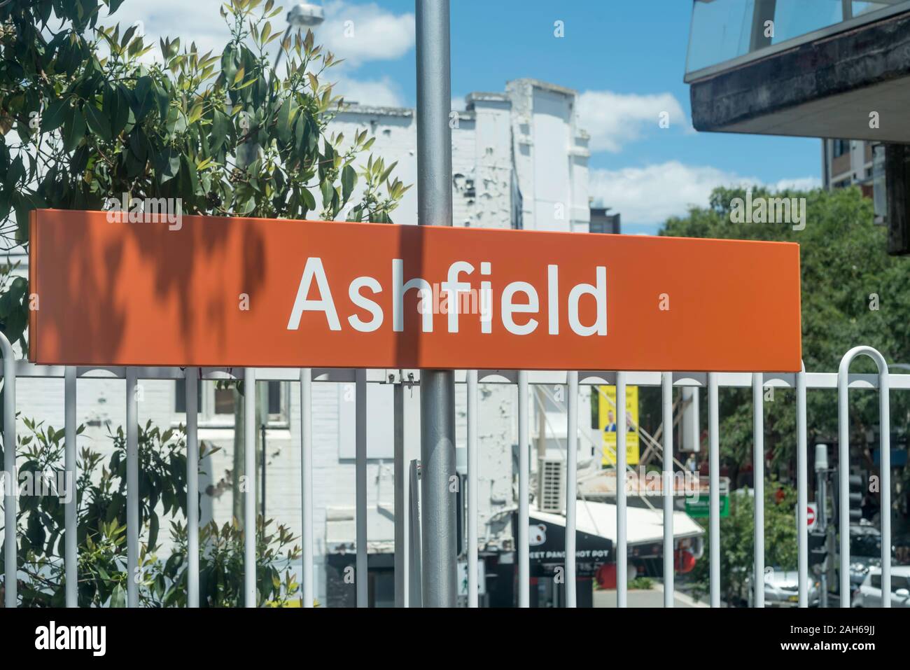 A bright orange and white lettering sign announces Ashfield Railway ...