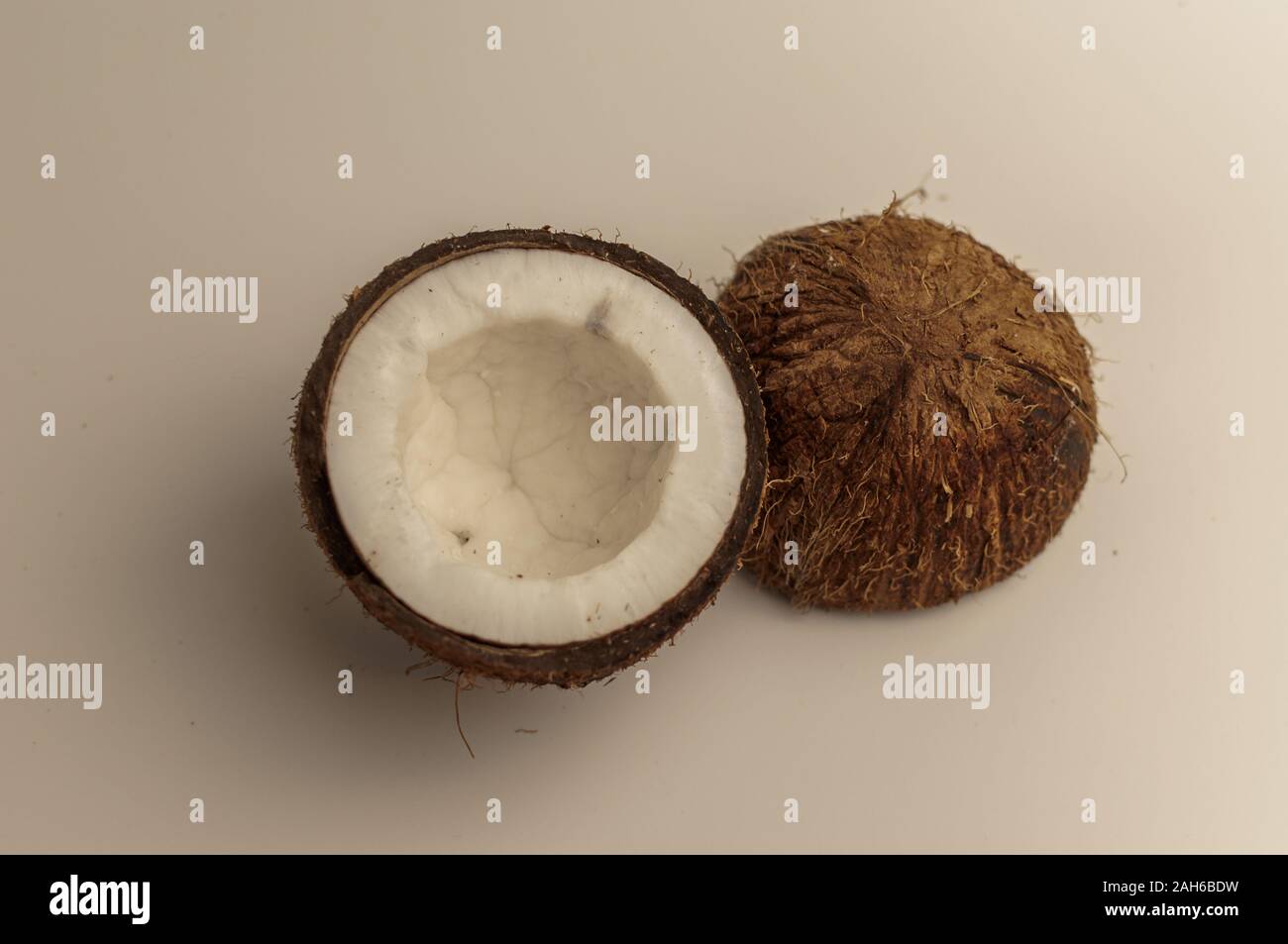 ugly organic coconut on a white background, isolate. a broken nut in a ...