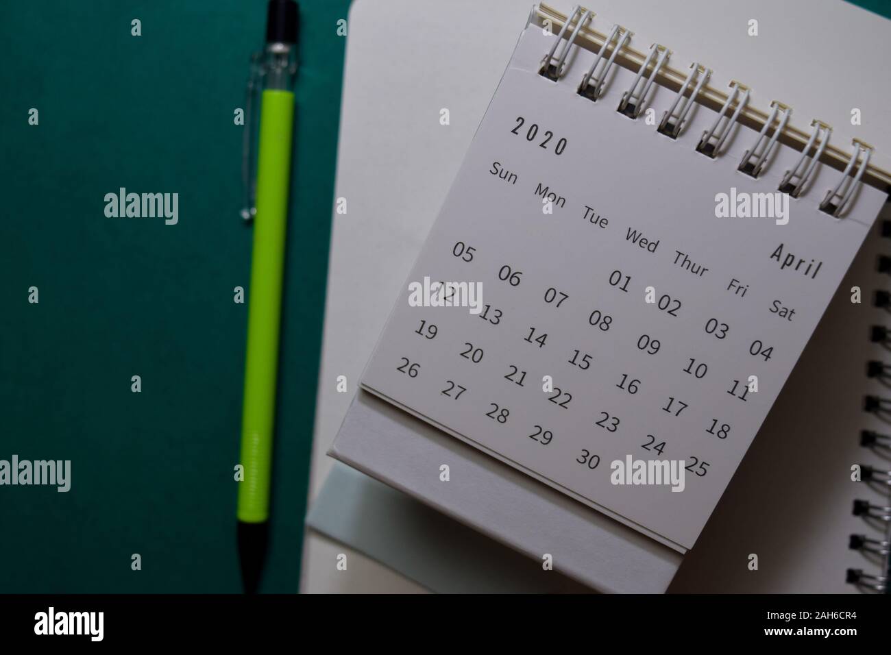 White Calendar April 2020 on office desk background Stock Photo - Alamy
