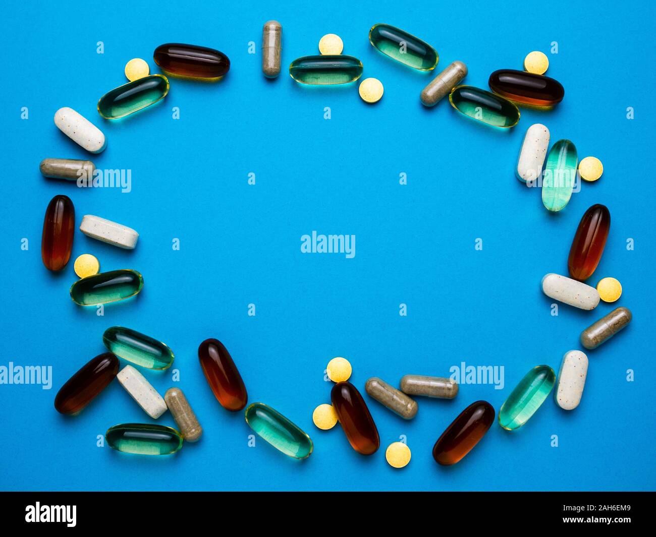 Spilled colored medications and pills on a blue background ...