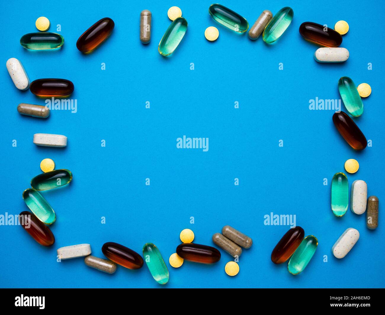 Spilled colored medications and pills on a blue background ...