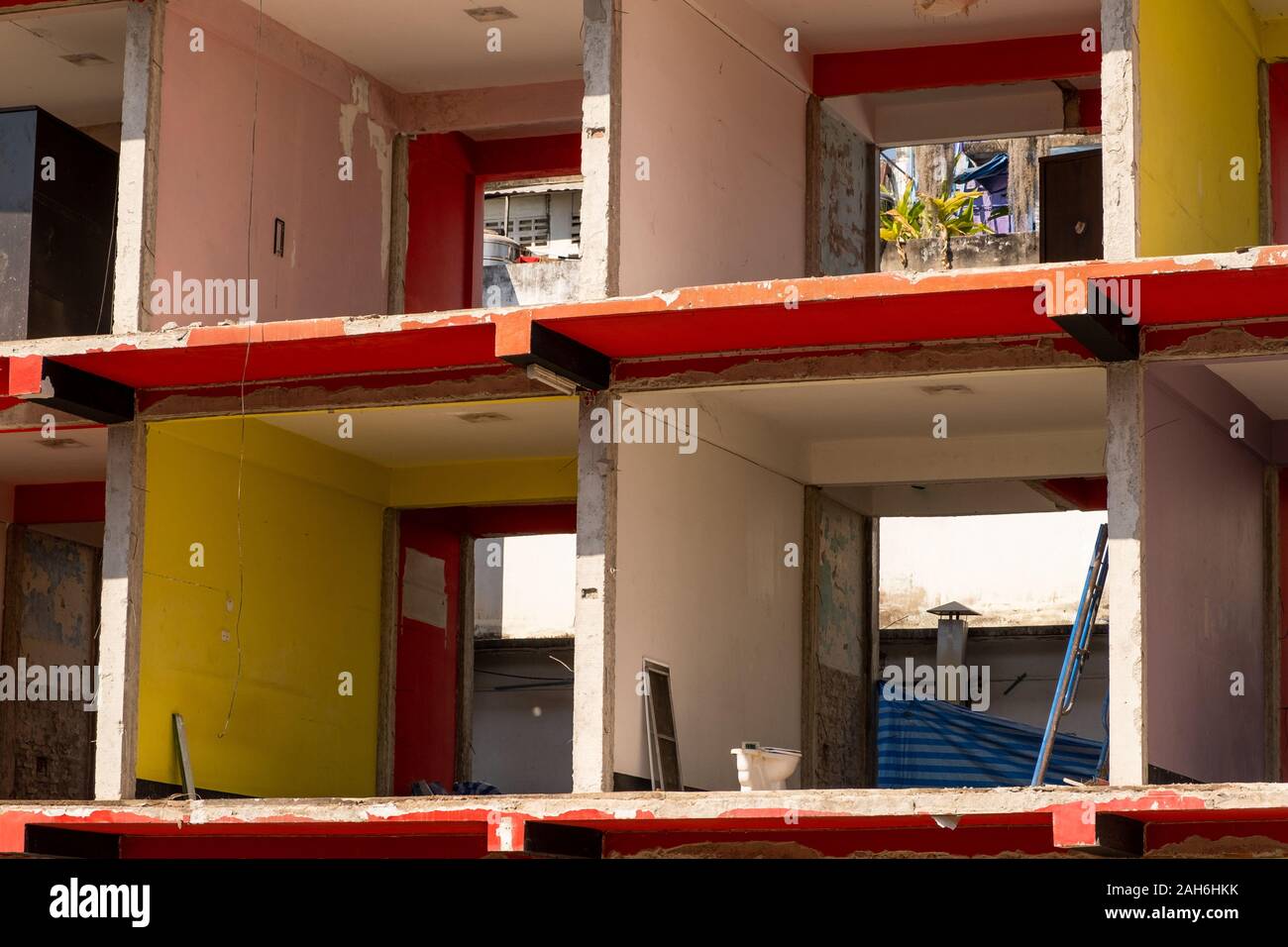 An old abandoned derelict block of flats with the front removed showing ...