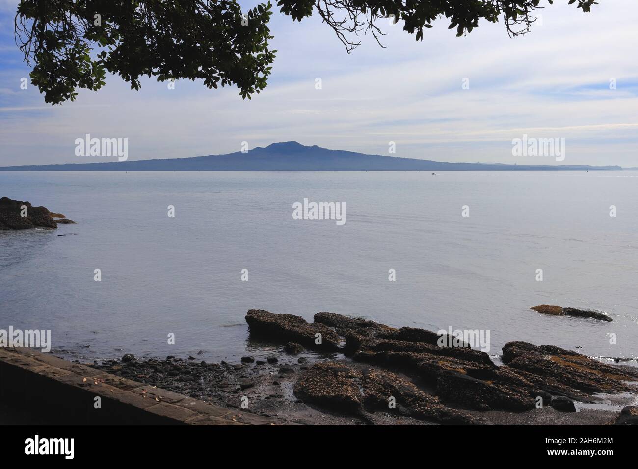 A view of Rangitoto Island in Hauraki Gulf seen from the beach at ...