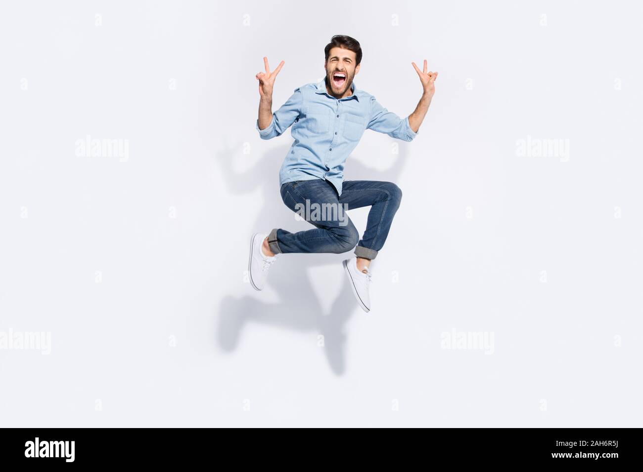 Full length photo of wild multiethnic guy jumping high yelling loud ...