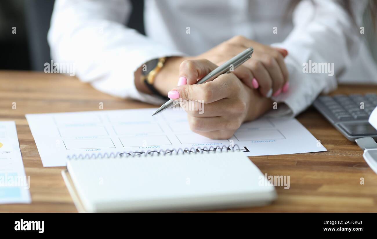 Female writing down in schedule Stock Photo - Alamy