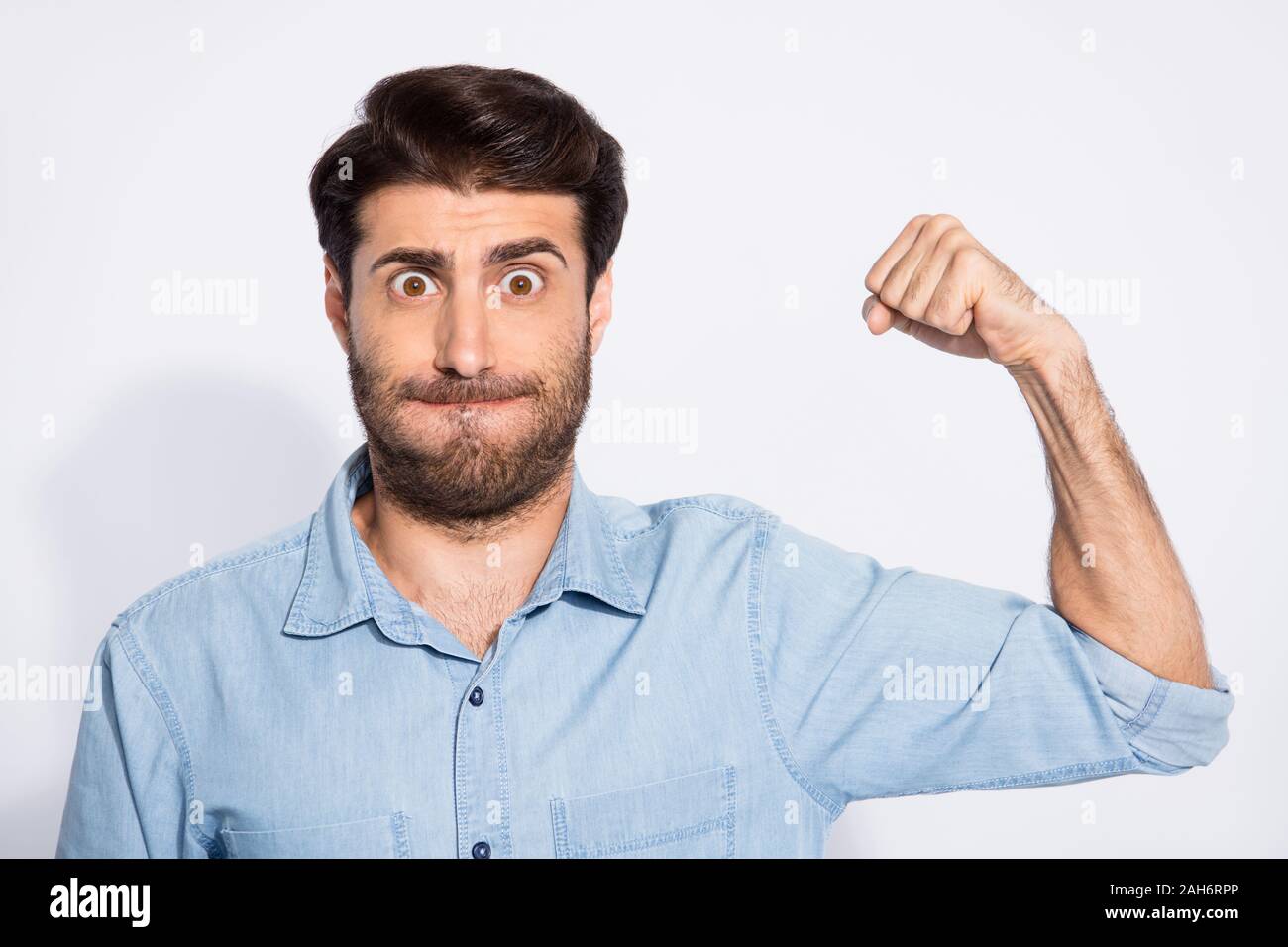 Photo of amazing handsome guy raising arm showing perfect biceps, shape ...