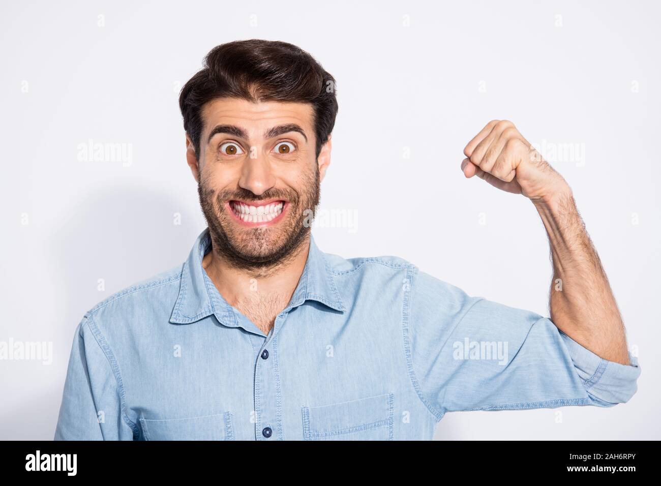 Photo of amazing handsome guy raising arm showing perfect biceps shape ...